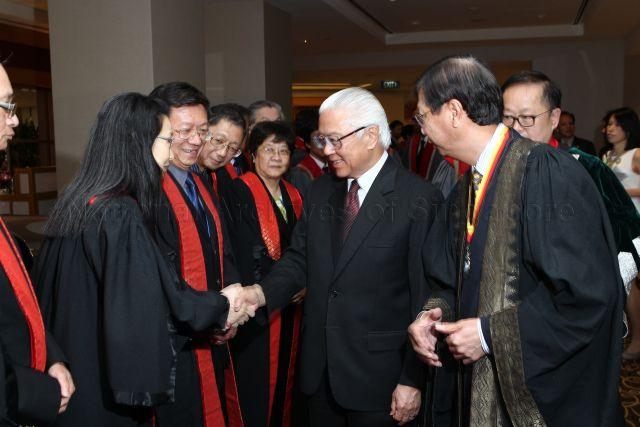 President Tony Tan Keng Yam is shaking hands with an