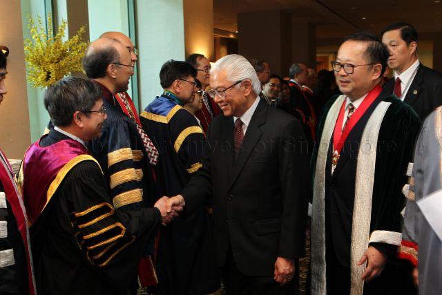 President Tony Tan Keng Yam is shaking hands with an