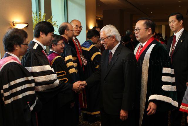 President Tony Tan Keng Yam is shaking hands with an