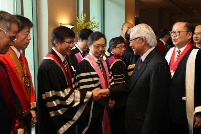 President Tony Tan Keng Yam is shaking hands with an