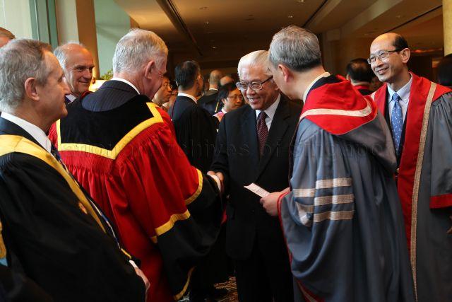 President Tony Tan Keng Yam is shaking hands with an