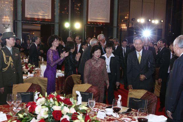 Mrs Mary Tan (wife of President Tony Tan) is being escorted