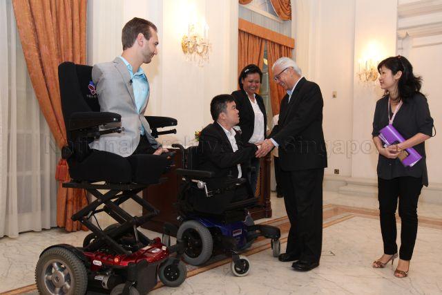 President Tony Tan (4th from left) shaking hands with Jason