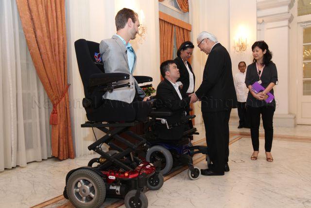President Tony Tan (4th from left) shaking hands with Jason