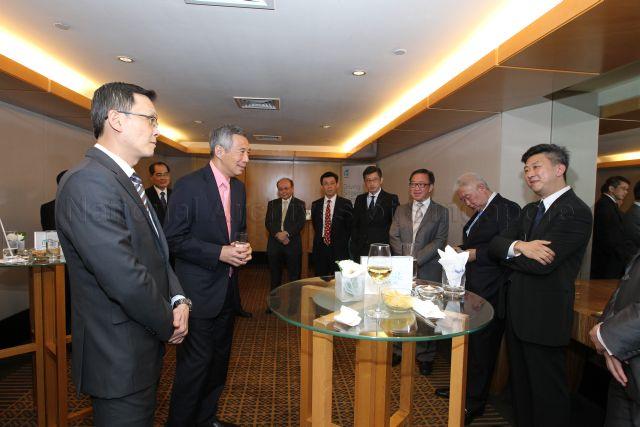 Prime Minister Lee Hsien Loong interacting with (5th and 6th
