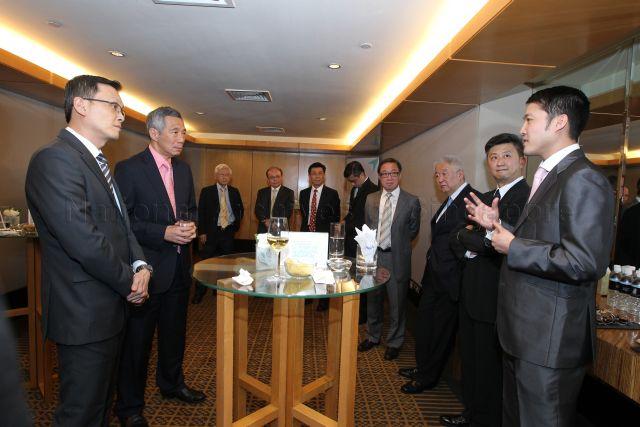 Prime Minister Lee Hsien Loong interacting with (5th from