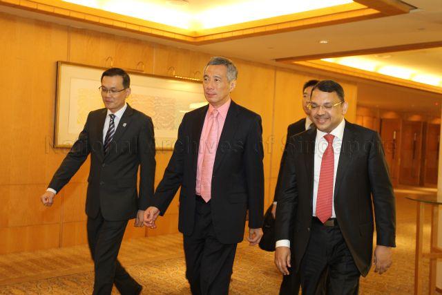 Prime Minister Lee Hsien Loong being escorted by (on the