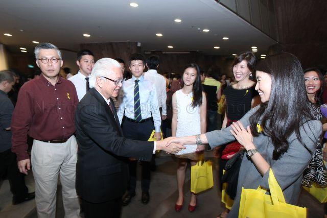 President Tony Tan shaking hands with a guest at the