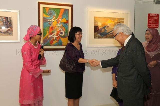 President Tony Tan and his wife Mrs Mary Tan (hidden) being