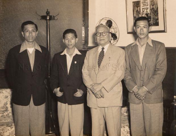 Group photograph of Aw Boon Haw and the three
