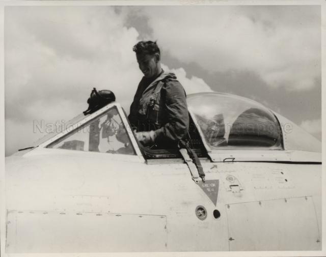 Pilot Officer Harris standing inside the cockpit of the