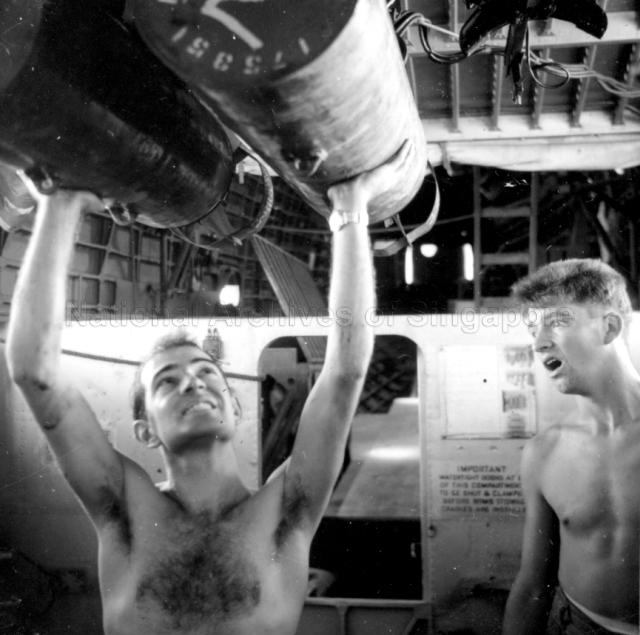 Photograph of airmen loading depth charges onto Sunderland