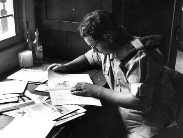 Photograph of Charles Beamish working at his desk