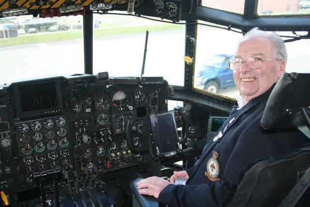 Photograph of Bob posing as a co-pilot in the cockpit of an