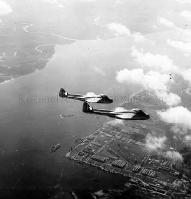 Photograph of two De Havilland Vampires in flight.