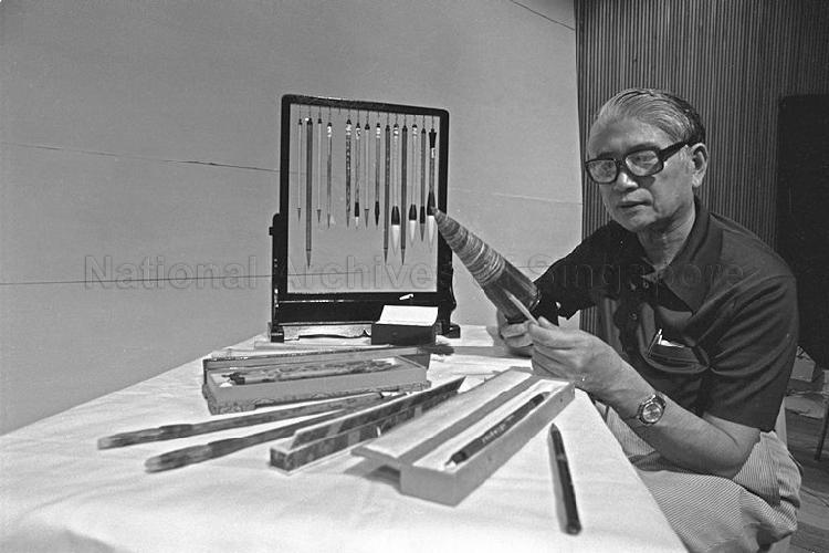 LOCAL ARTIST HUANG PAO FANG SHOWING HIS COLLECTION OF