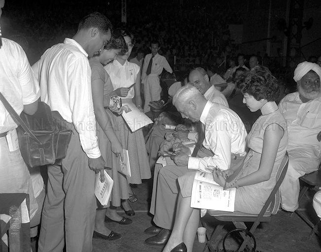 SIR GEORGE THOMAS SIGNING AUTOGRAPHS DURING THE THOMAS CUP