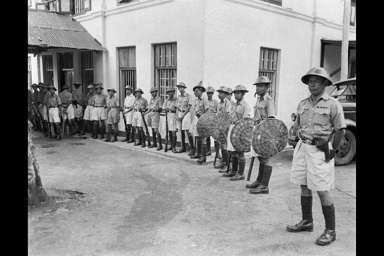 ANTI-RIOT POLICE, ARMED WITH WICKER SHIELDS, BATONS, STEEL